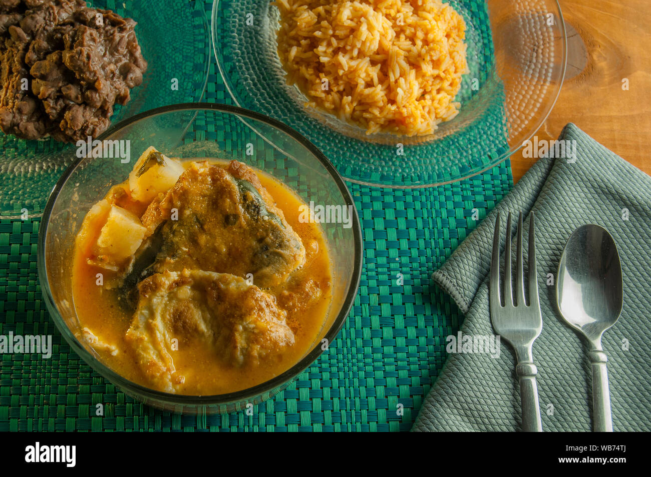 Chiles rellenos in a soup with beans and Mexican rice, as part of ...