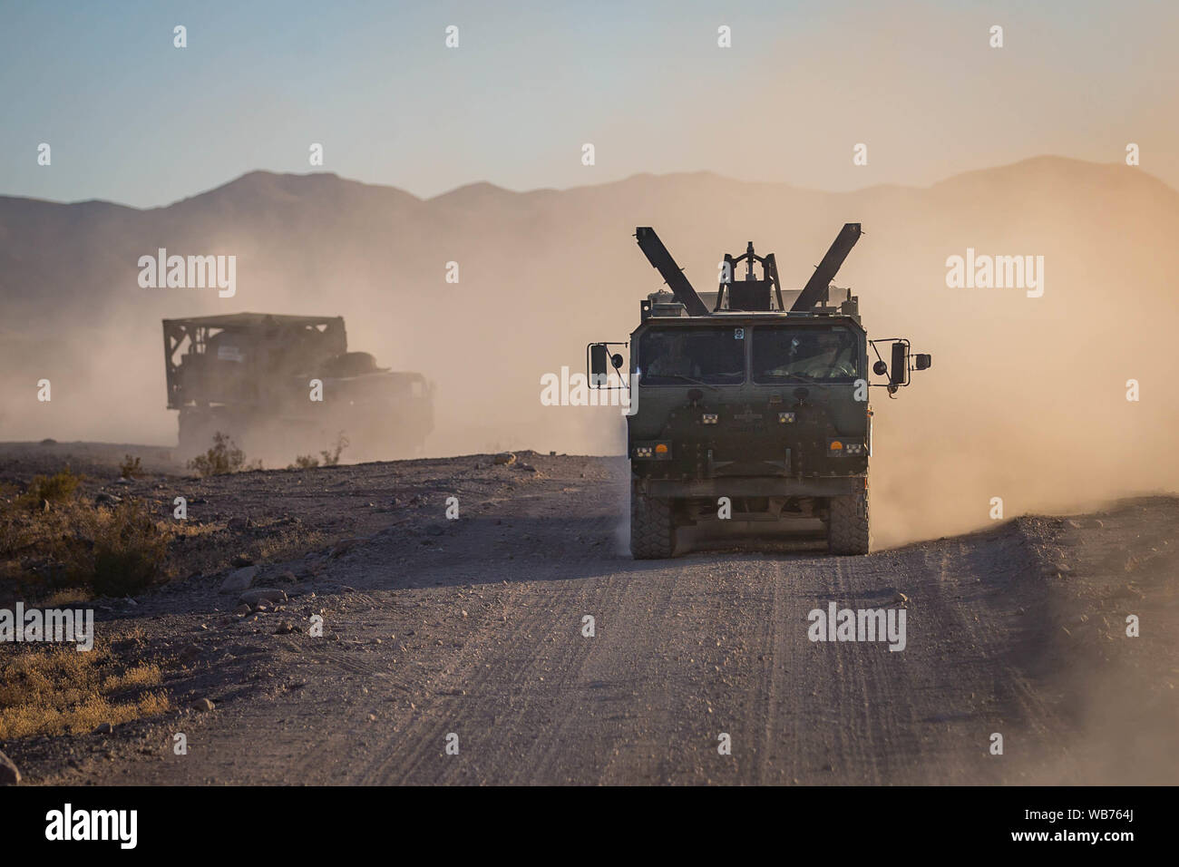 A Marine Corps logistics vehicle system replacement convoy down a main ...