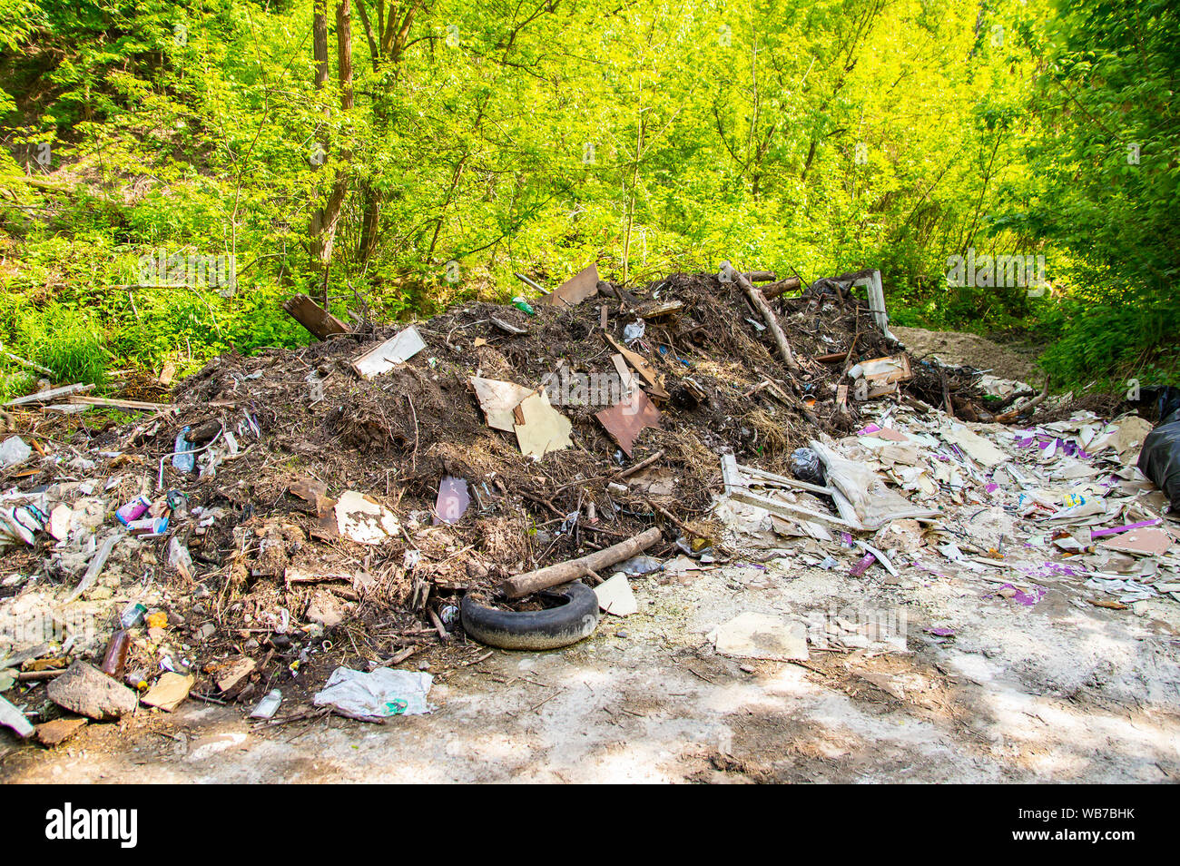 Garbage abandoned by people in nature - plastic packaging, plastic bags ...