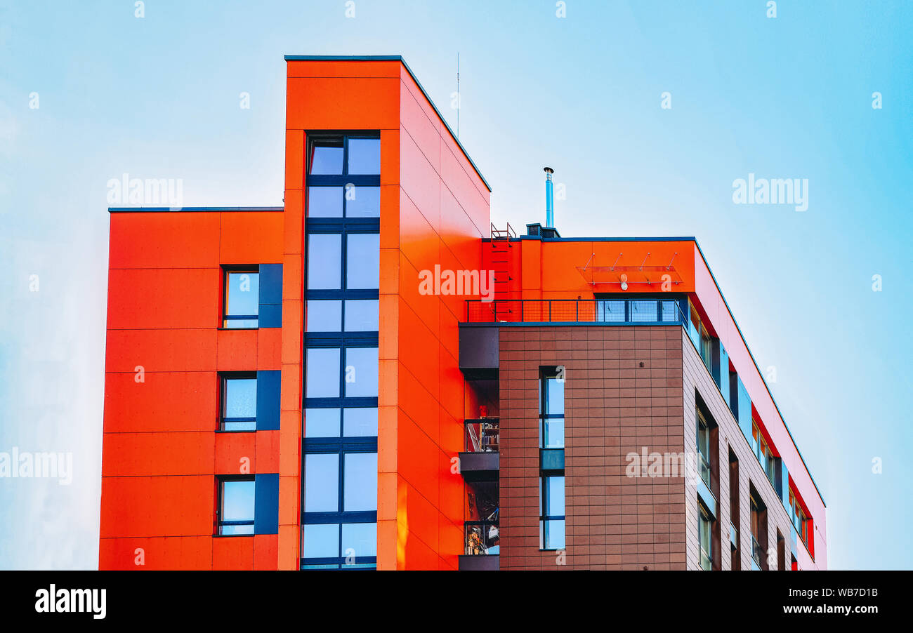 Facade of red modern apartment house building. Including place for copy ...