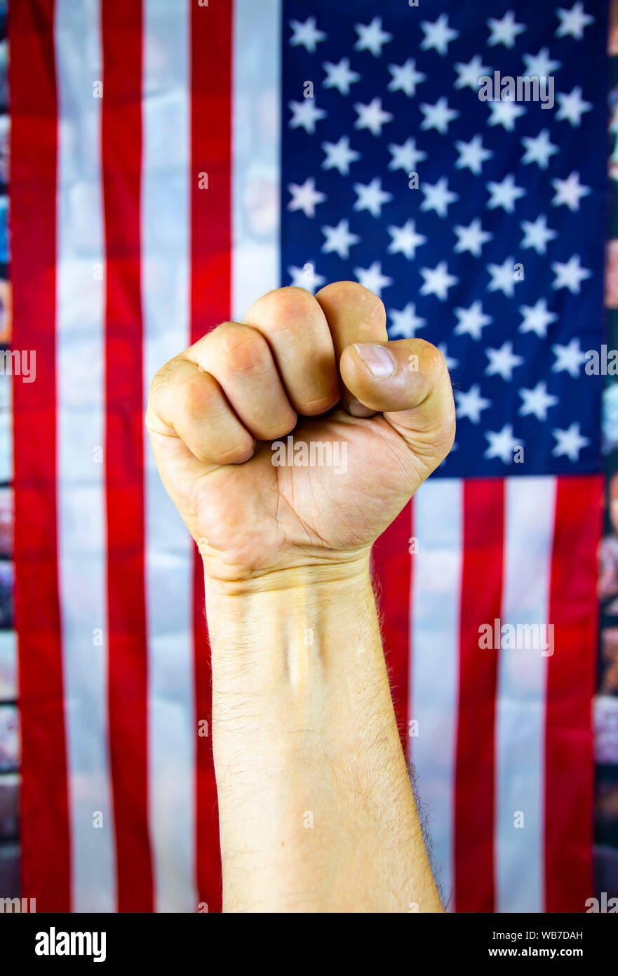 Hand gesture against the background of the flag of the United States of ...