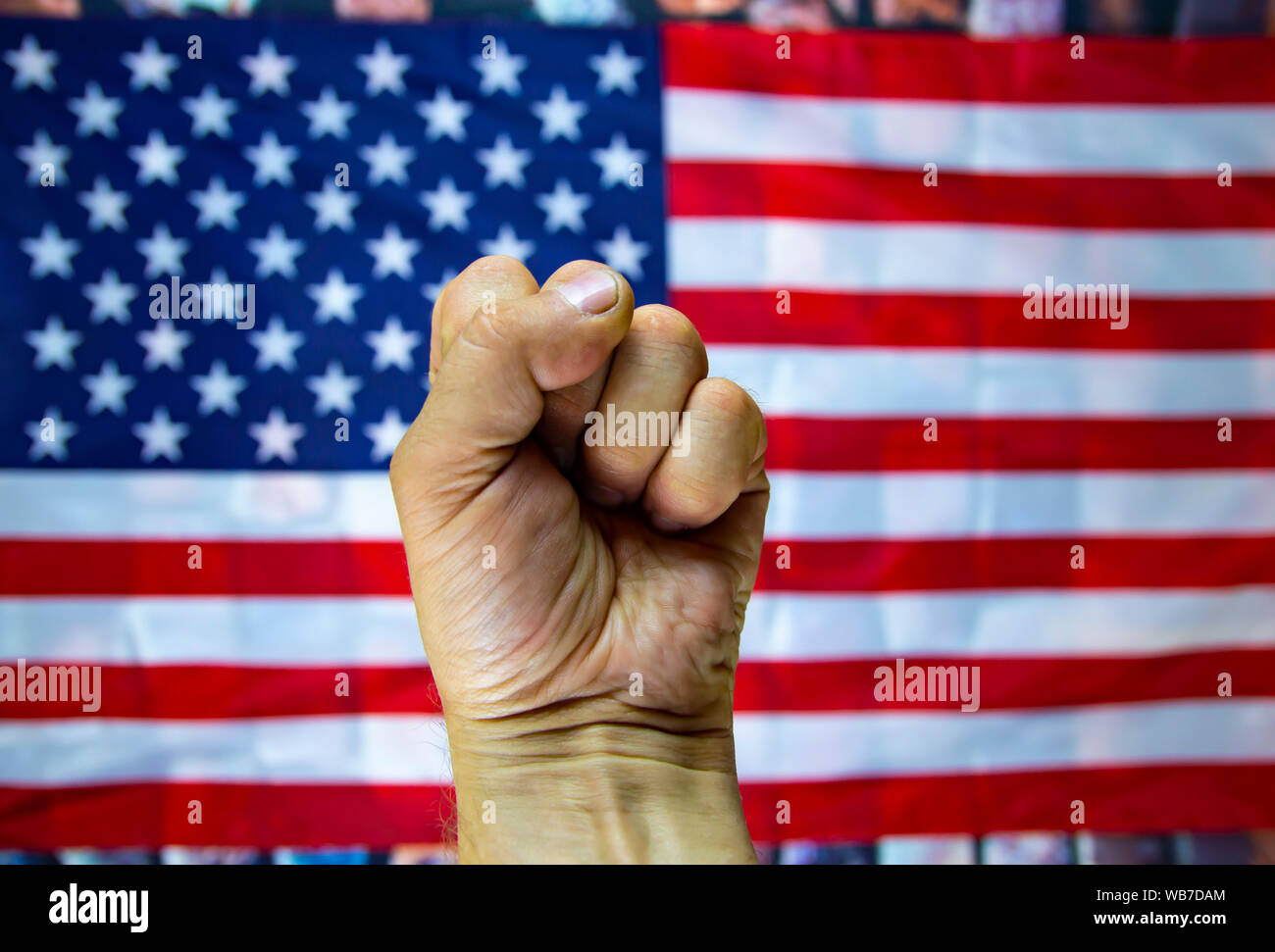 Hand gesture against the background of the flag of the United States of ...