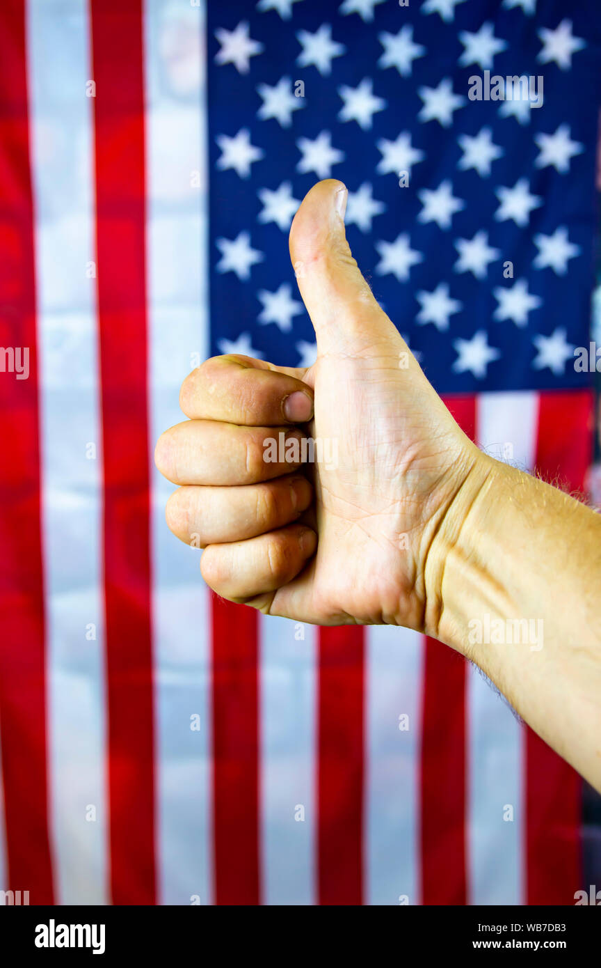 Hand gesture against the background of the flag of the United States of ...