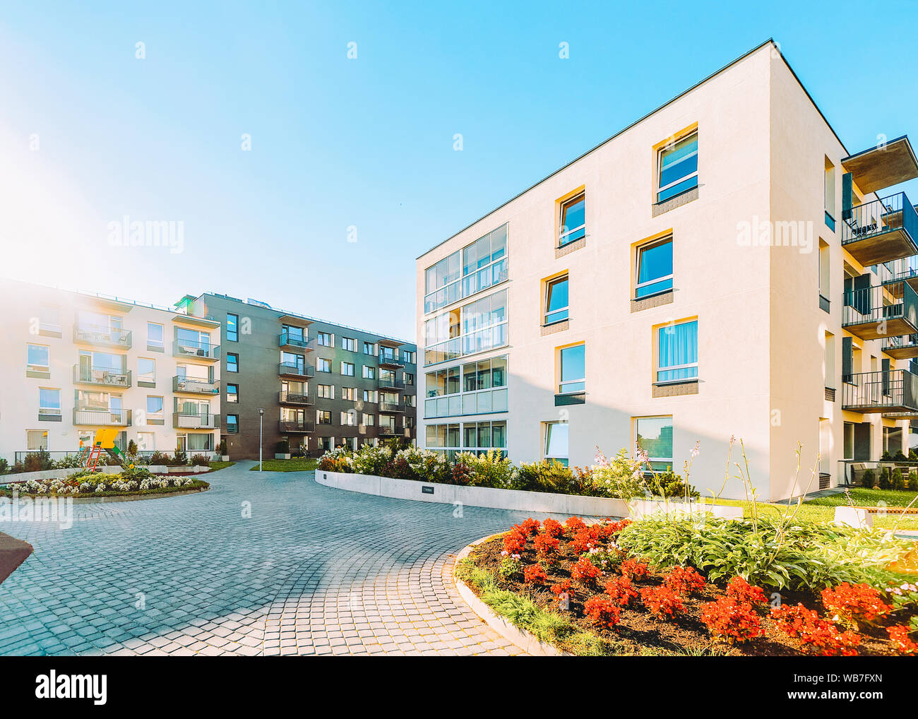 Complex of modern apartment residential buildings with flower plants ...
