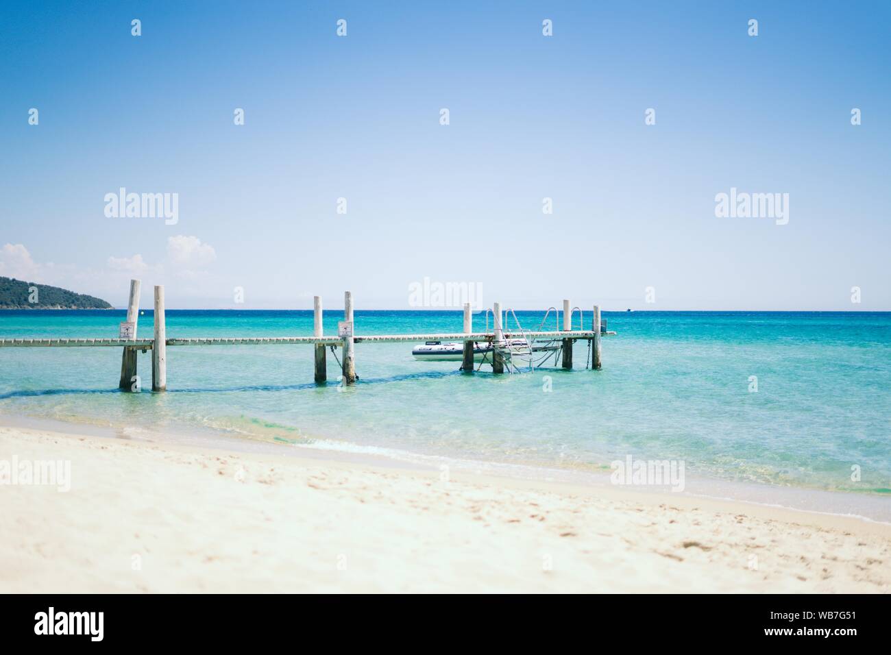 Wide shot of a white dock on the body of water Stock Photo - Alamy