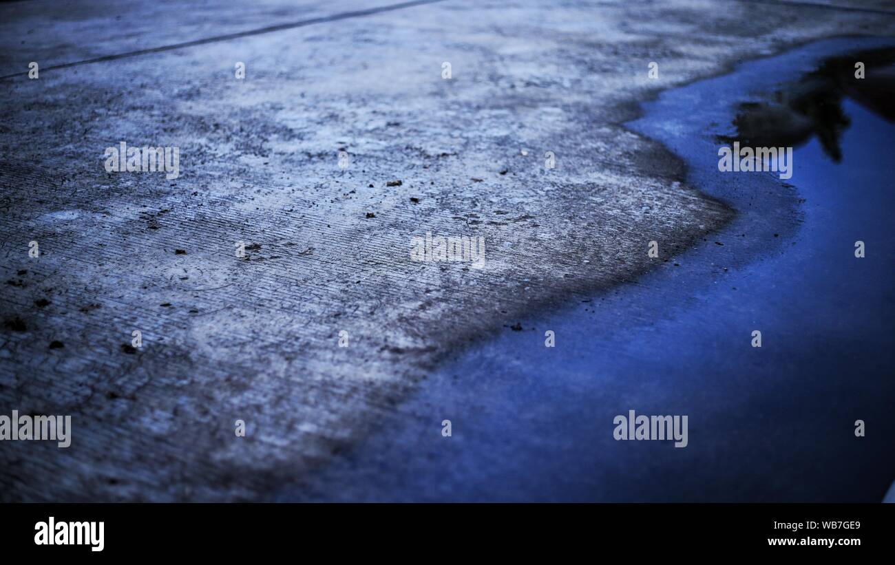 concrete road and flooding water. poor drainage system left puddle of ...
