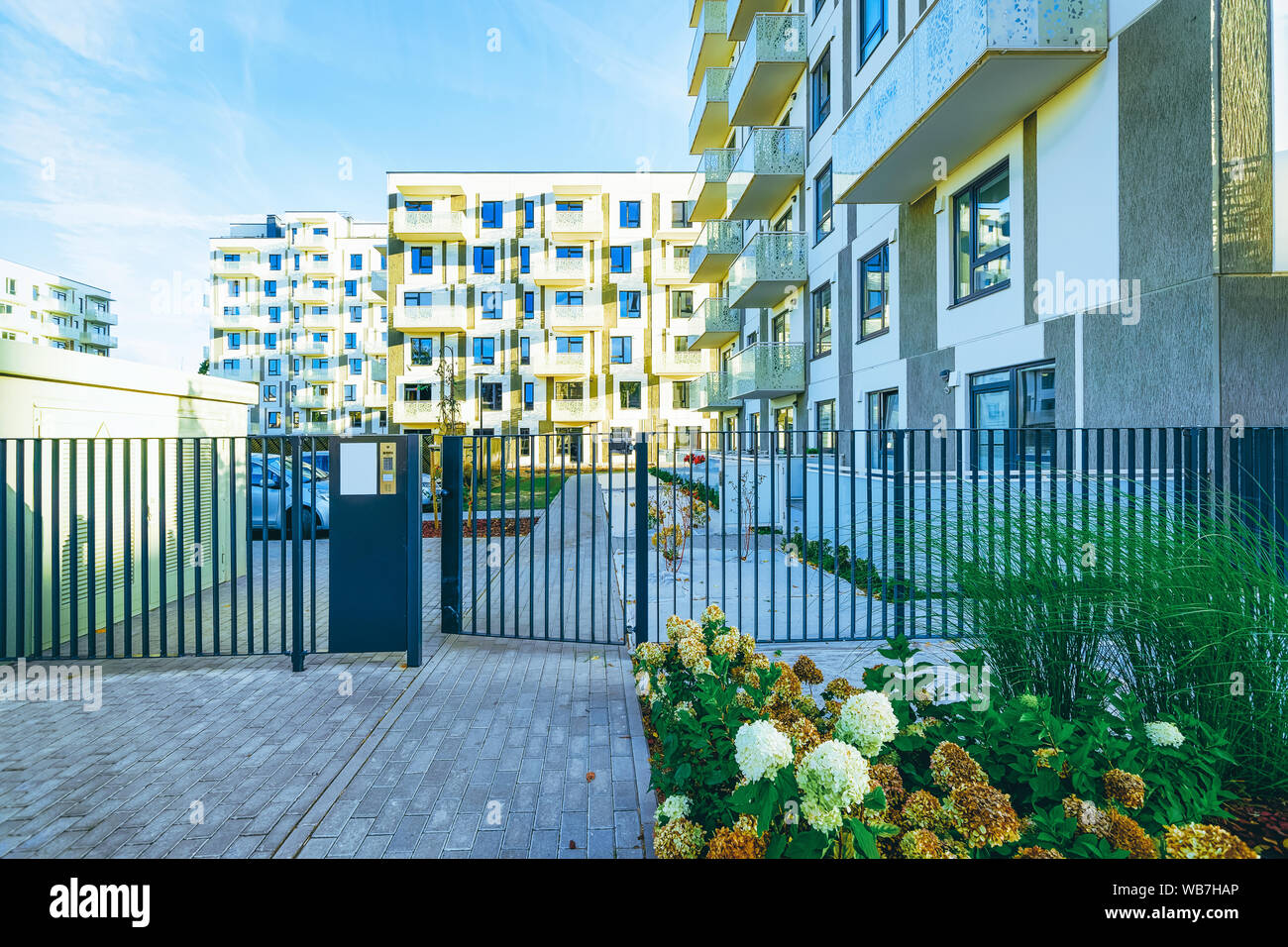 Modern new residential apartment house building with entrance gate ...