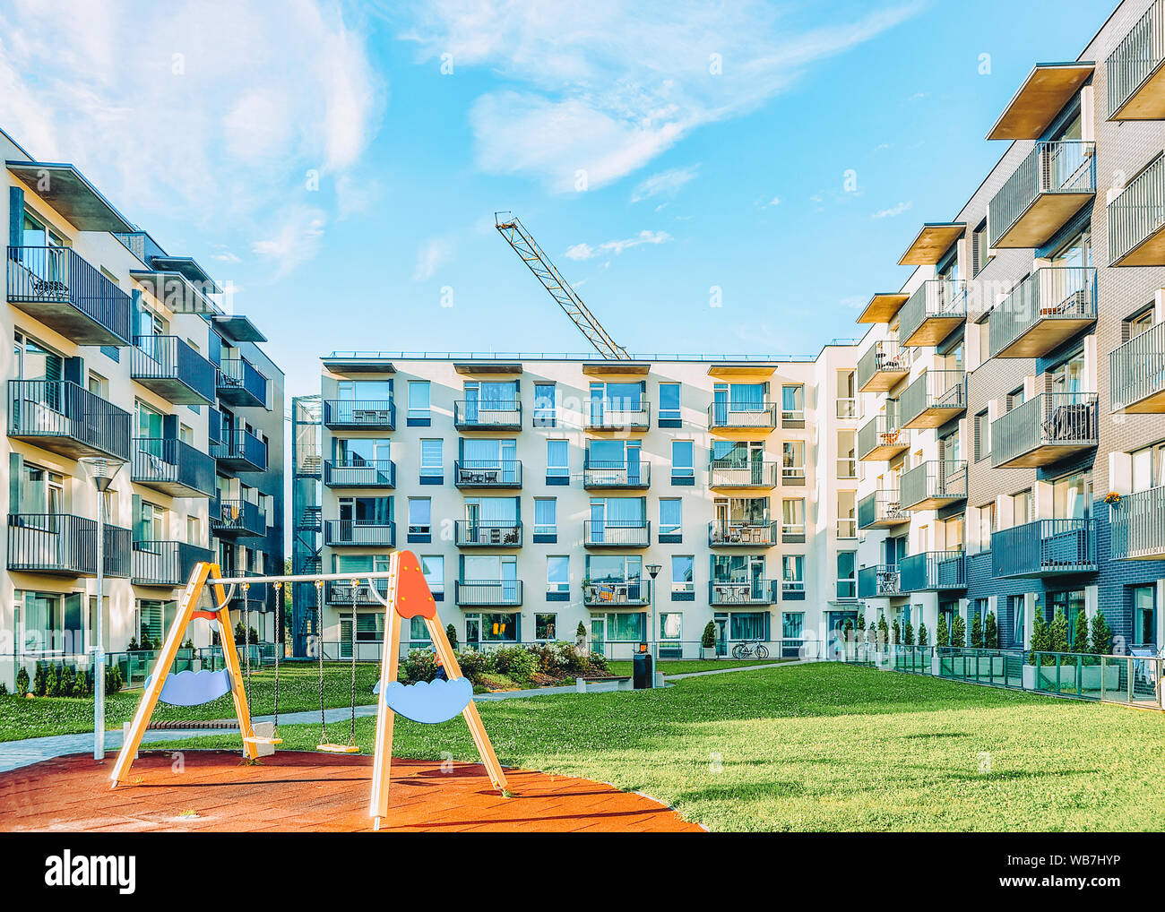 Complex of modern residential buildings with children playground as ...