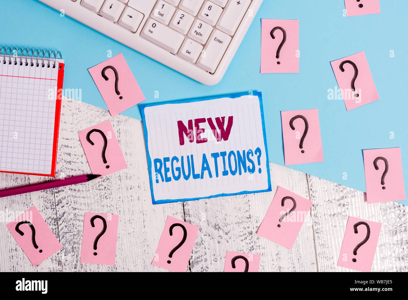 Writing note showing New Regulations Question. Business concept for ...