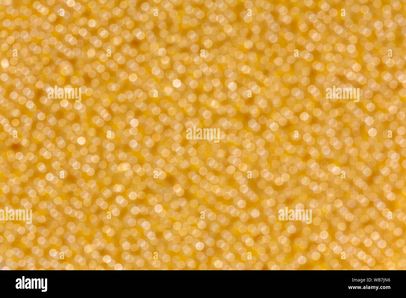 Abstract twinkled yellow, gold bright background with bokeh defocused ...