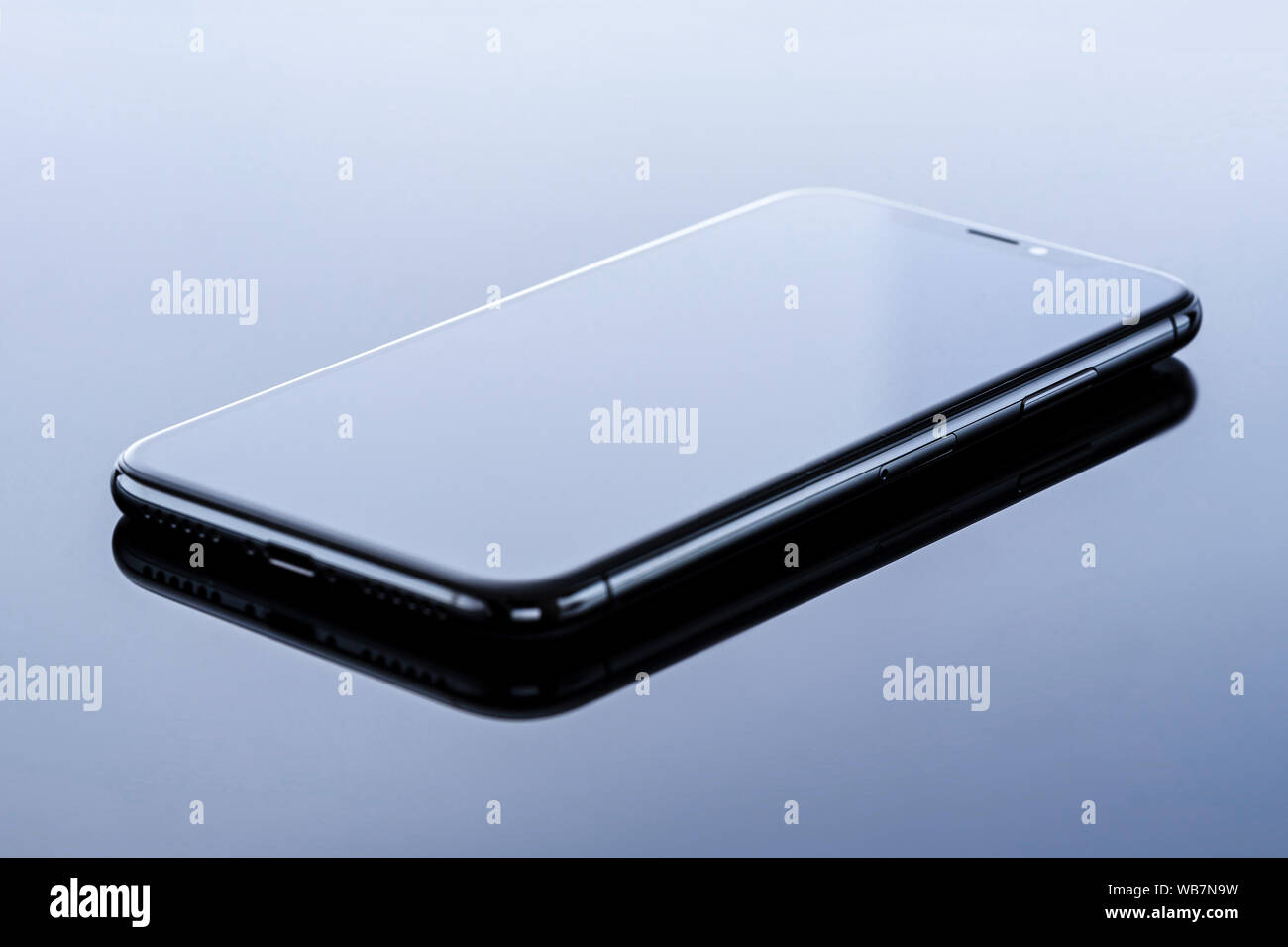 mobile phone on glass surface with beautiful gradient and gray ...