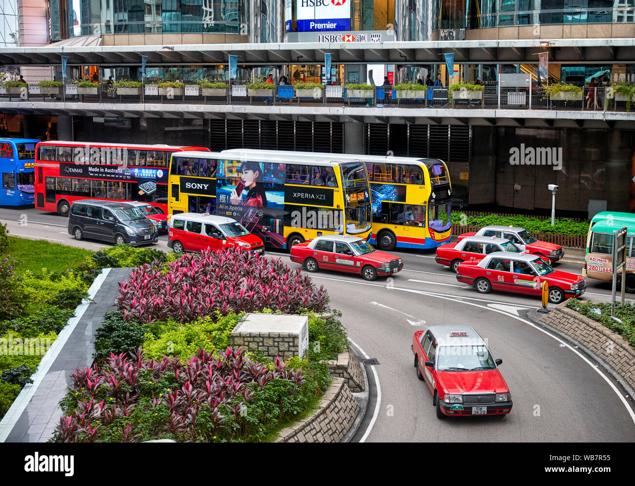 Red taxi cabs and double-decker buses in Central. Hong Kong, China ...