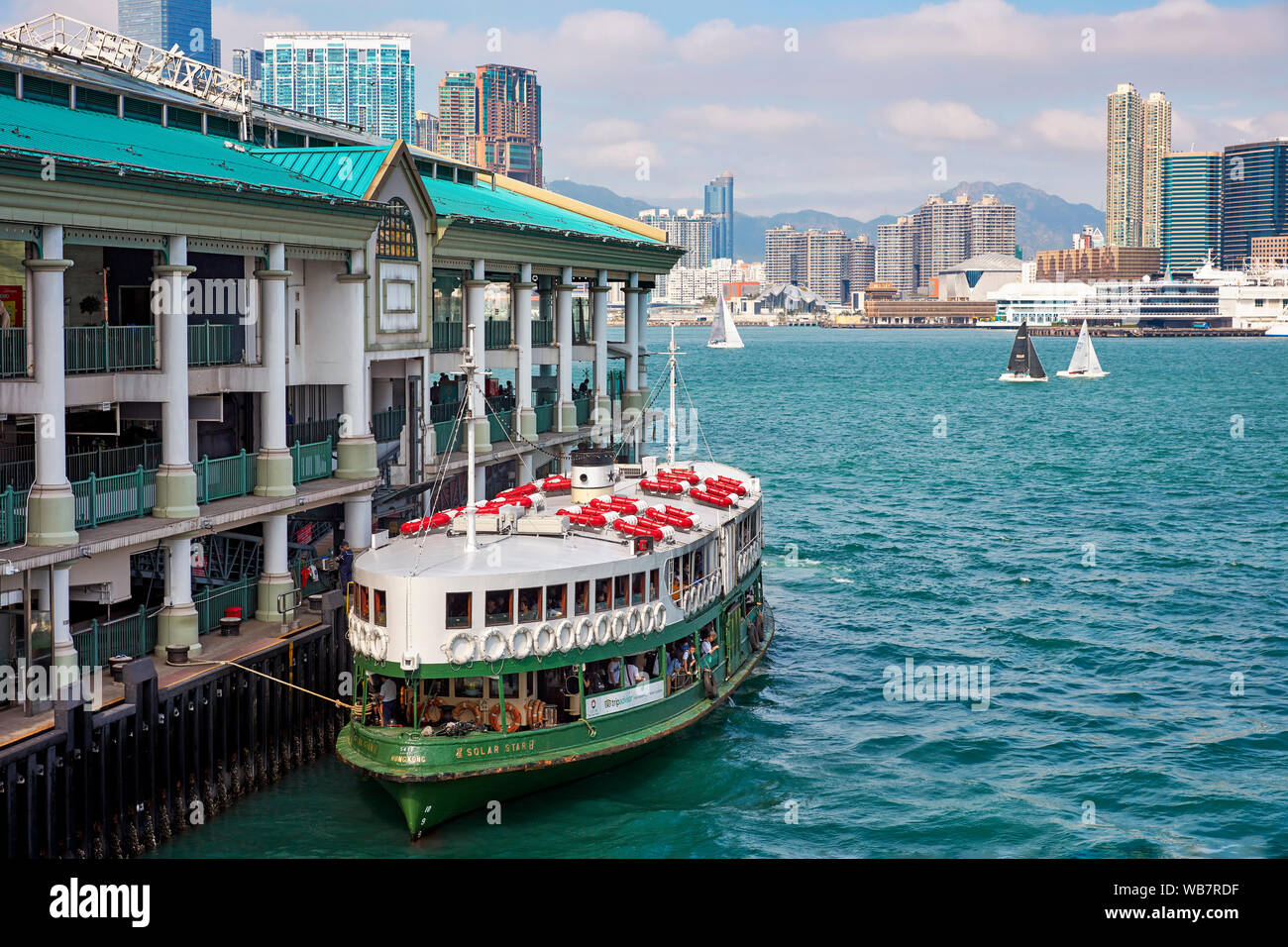 Star Ferry boat moored at Central Ferry Pier with Kowloon side in the ...