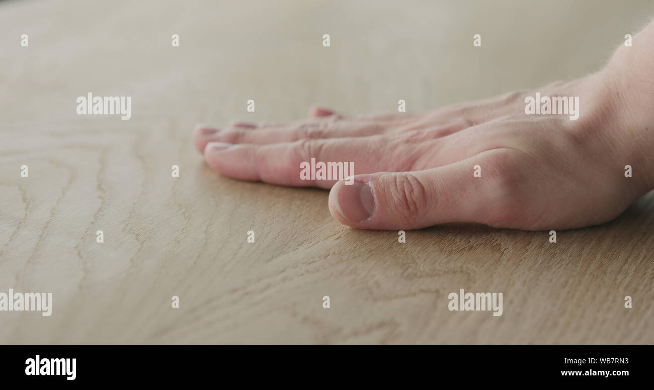 man hand check quality of oak wood surface, wide photo Stock Photo - Alamy