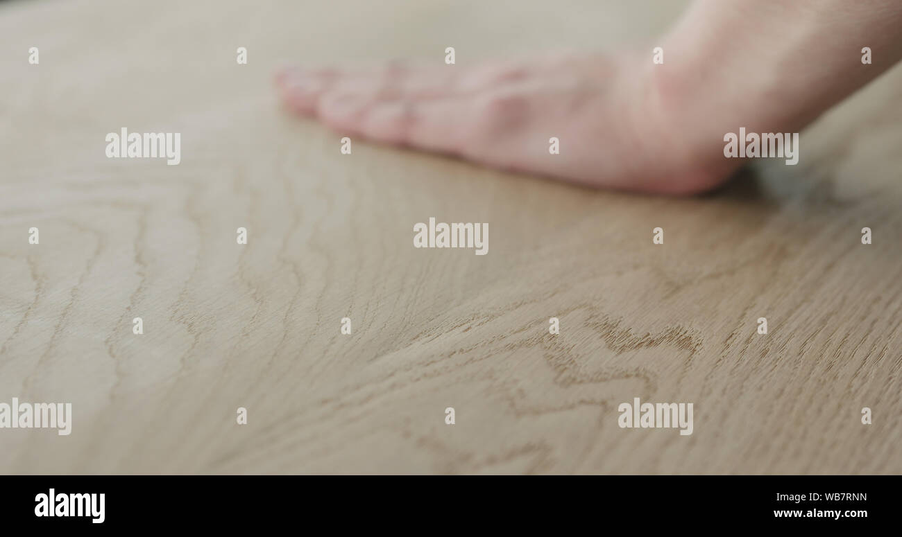 man hand check quality of oak wood surface, wide photo Stock Photo - Alamy
