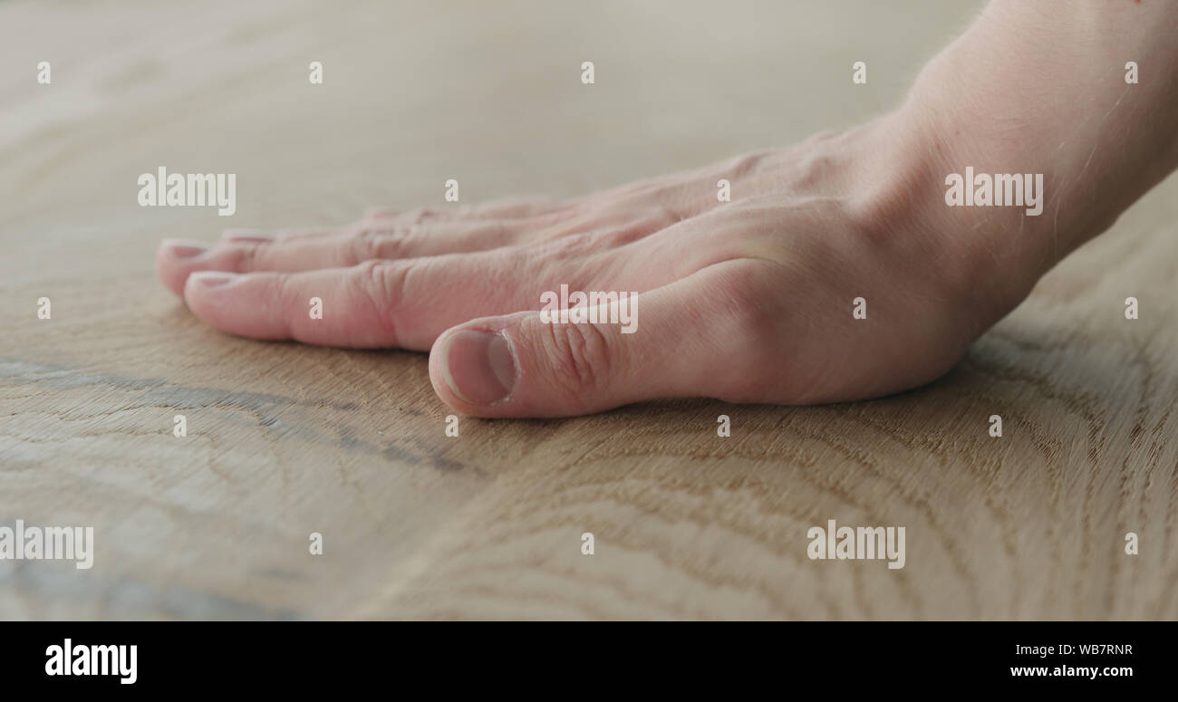 man hand check quality of oak wood surface, wide photo Stock Photo - Alamy