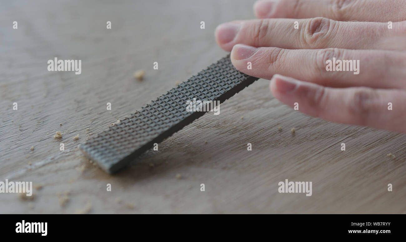 closeup man hand scraping oak board with file, wide photo Stock Photo ...