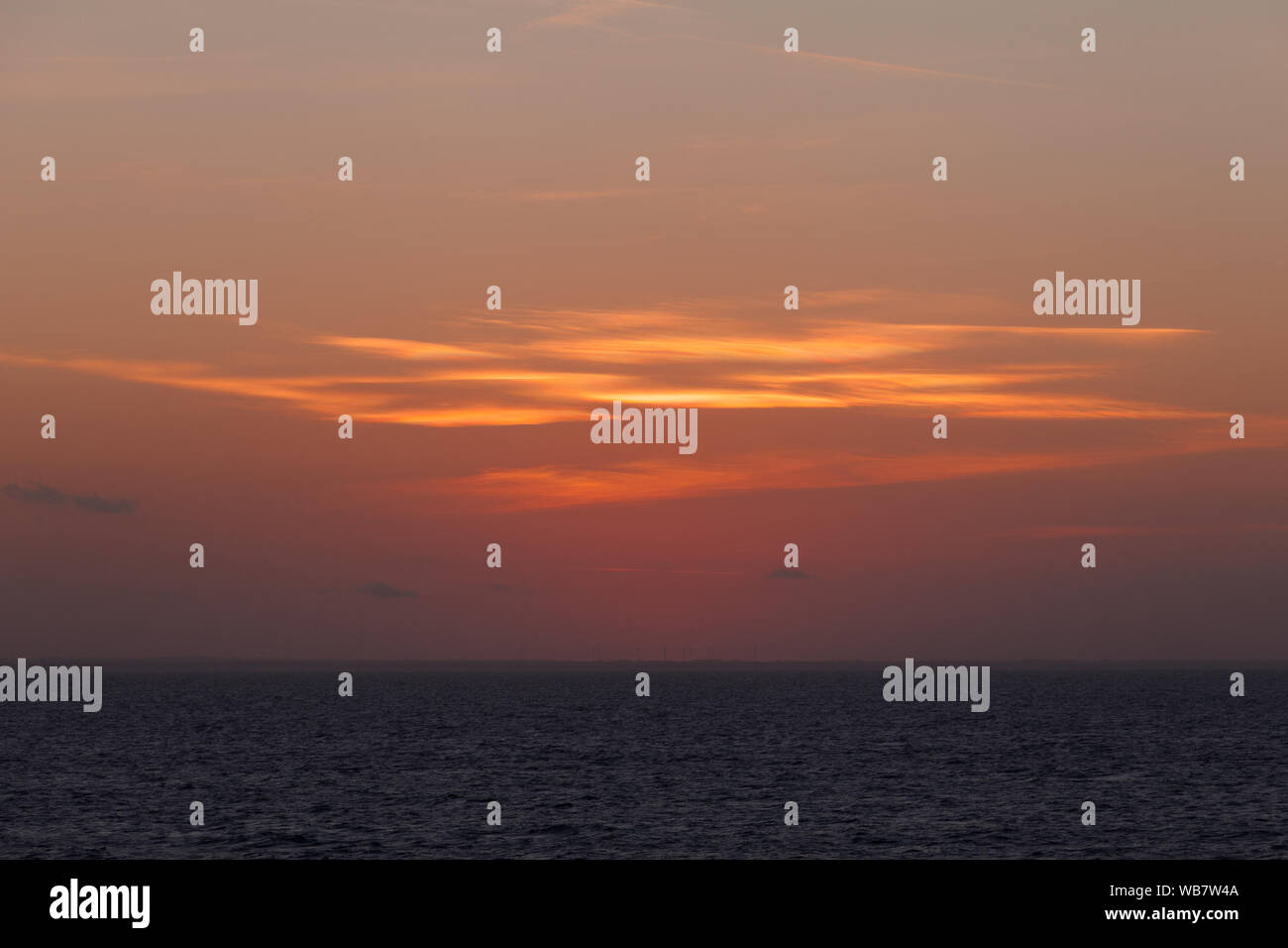 Orange sky and clouds right after sunset behind the italian coast Stock ...
