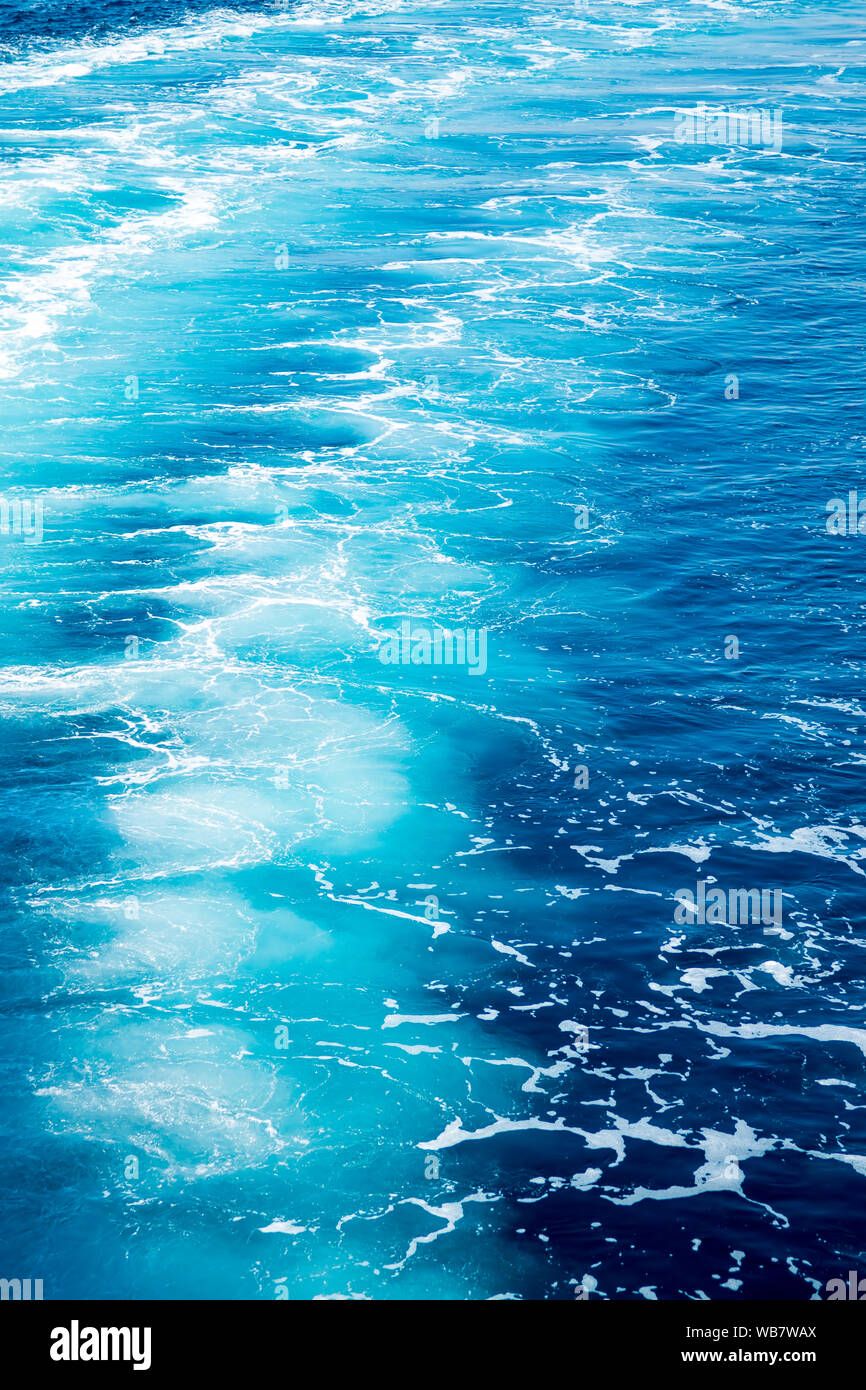 Trail on ocean water surface behind of fast moving powerful engines ...