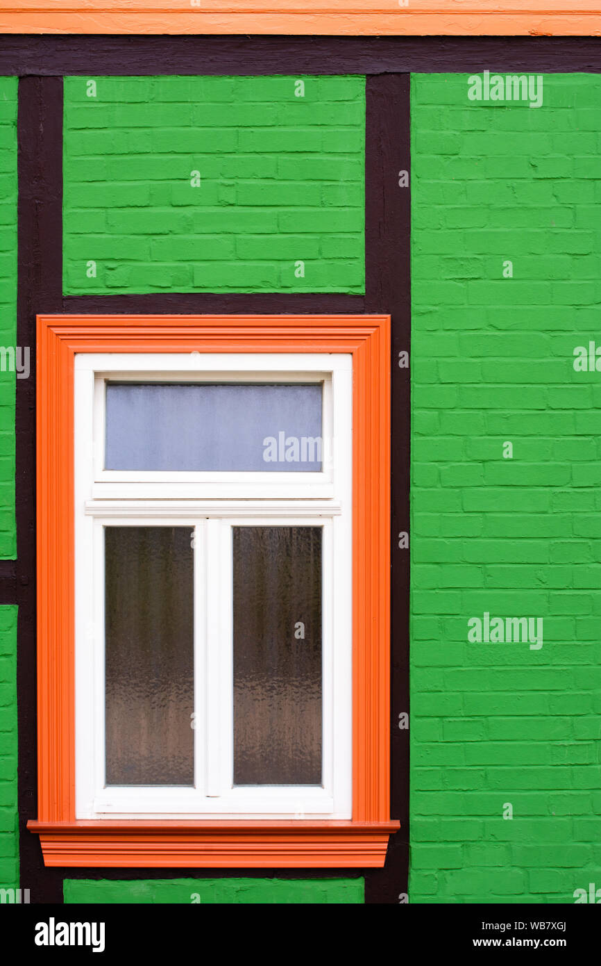 Colorful half-timbered architecture - orange window frame on a green ...