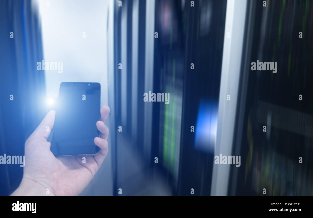 mobile phone in hand on server room background Stock Photo - Alamy