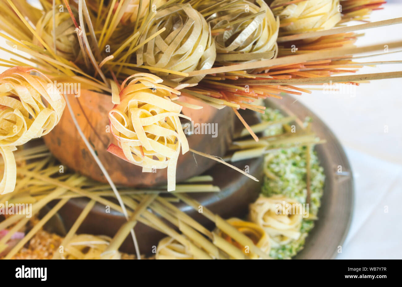Arrangement of various types of pasta on display against a white ...