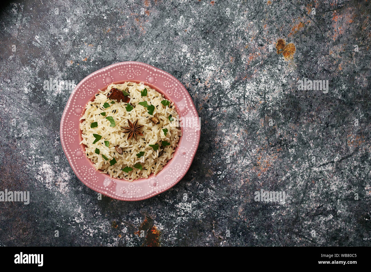 Jeera Rice in pink plate at dark bacgkround. Jeera rice - traditional ...