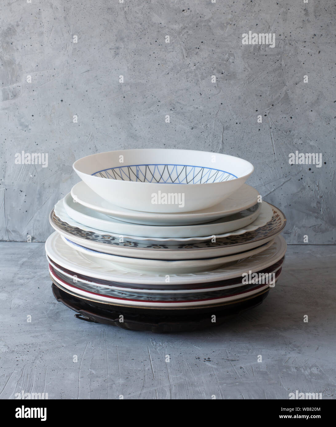 Clean dishes on the table in a stack on a gray background Stock Photo ...