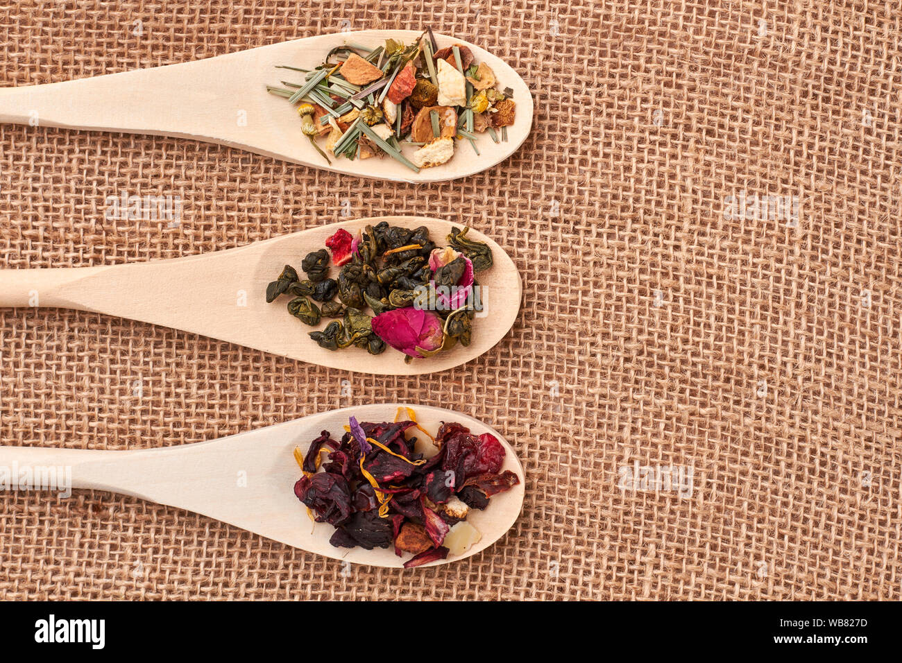 Three wooden spoons with assorted tea leaves Stock Photo - Alamy