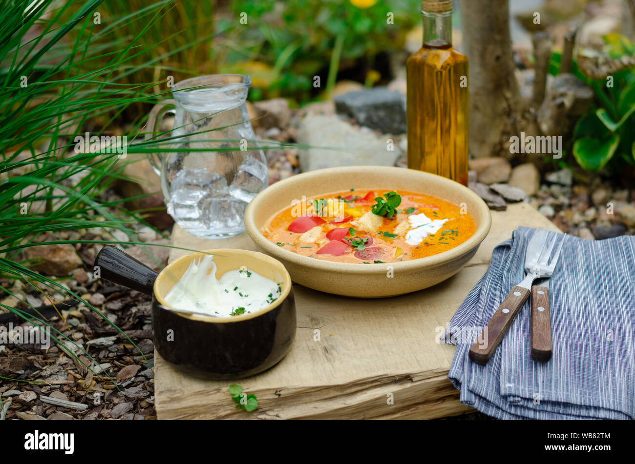 Simple and spicy chicken curry, outside cooking near beautiful garden ...