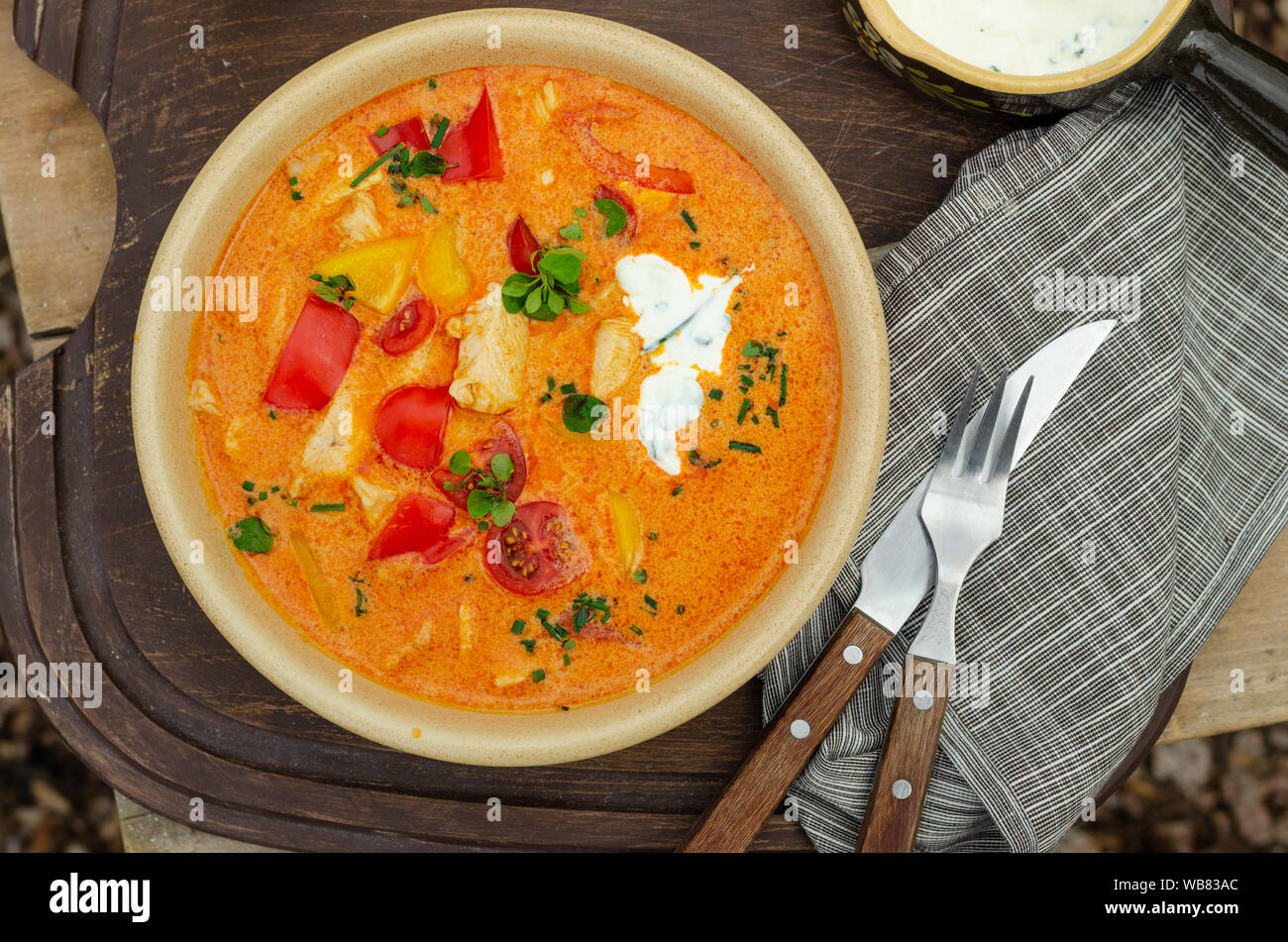 Simple and spicy chicken curry, outside cooking near beautiful garden ...