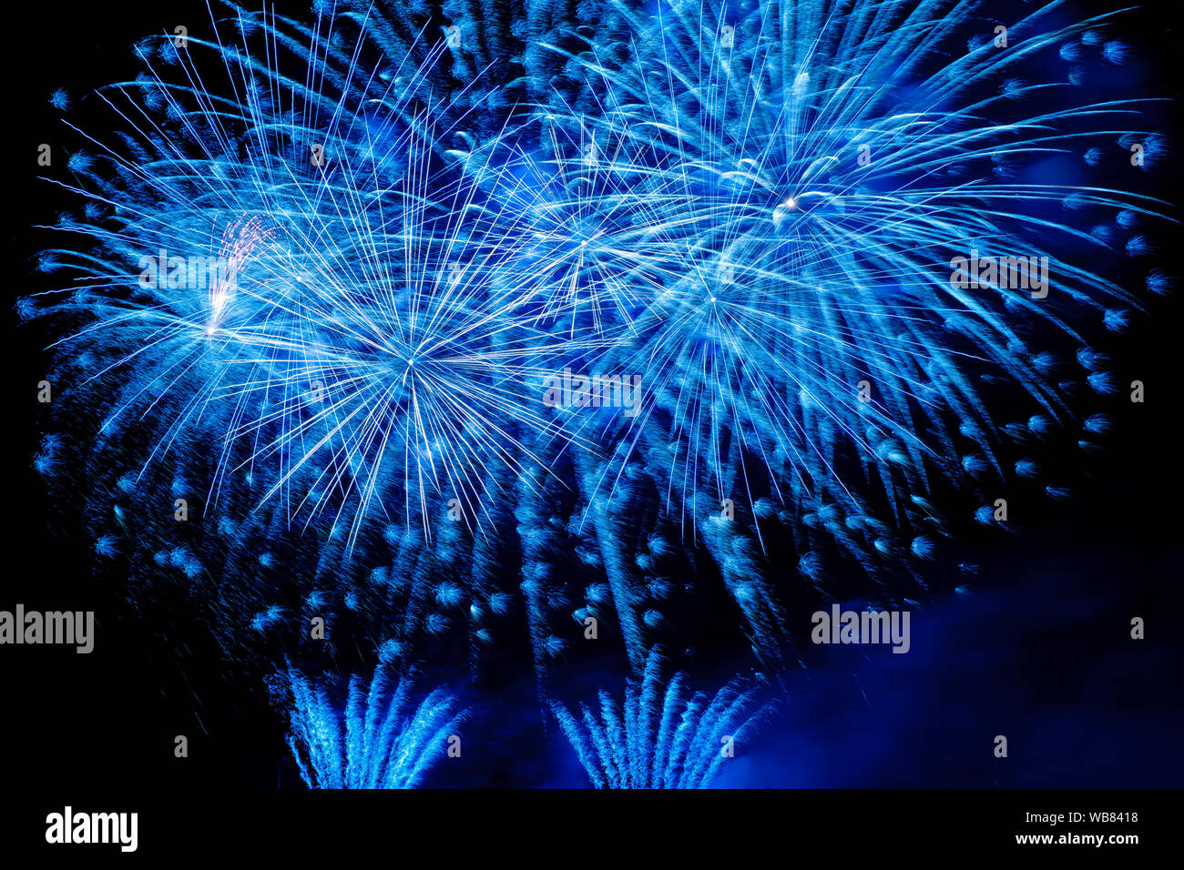 Colorful fireworks in night sky background Stock Photo - Alamy