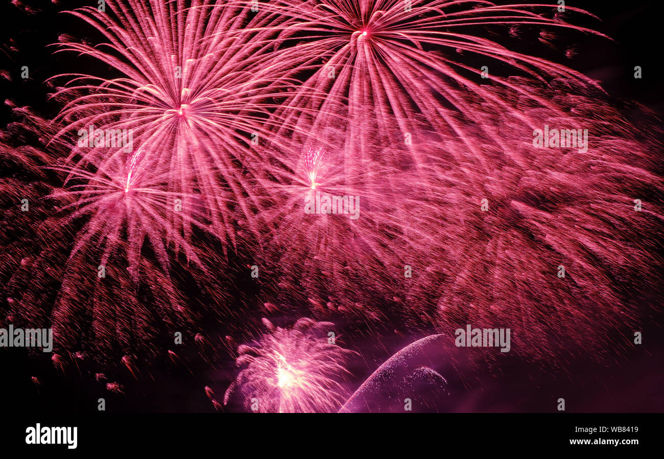 Colorful fireworks in night sky background Stock Photo - Alamy
