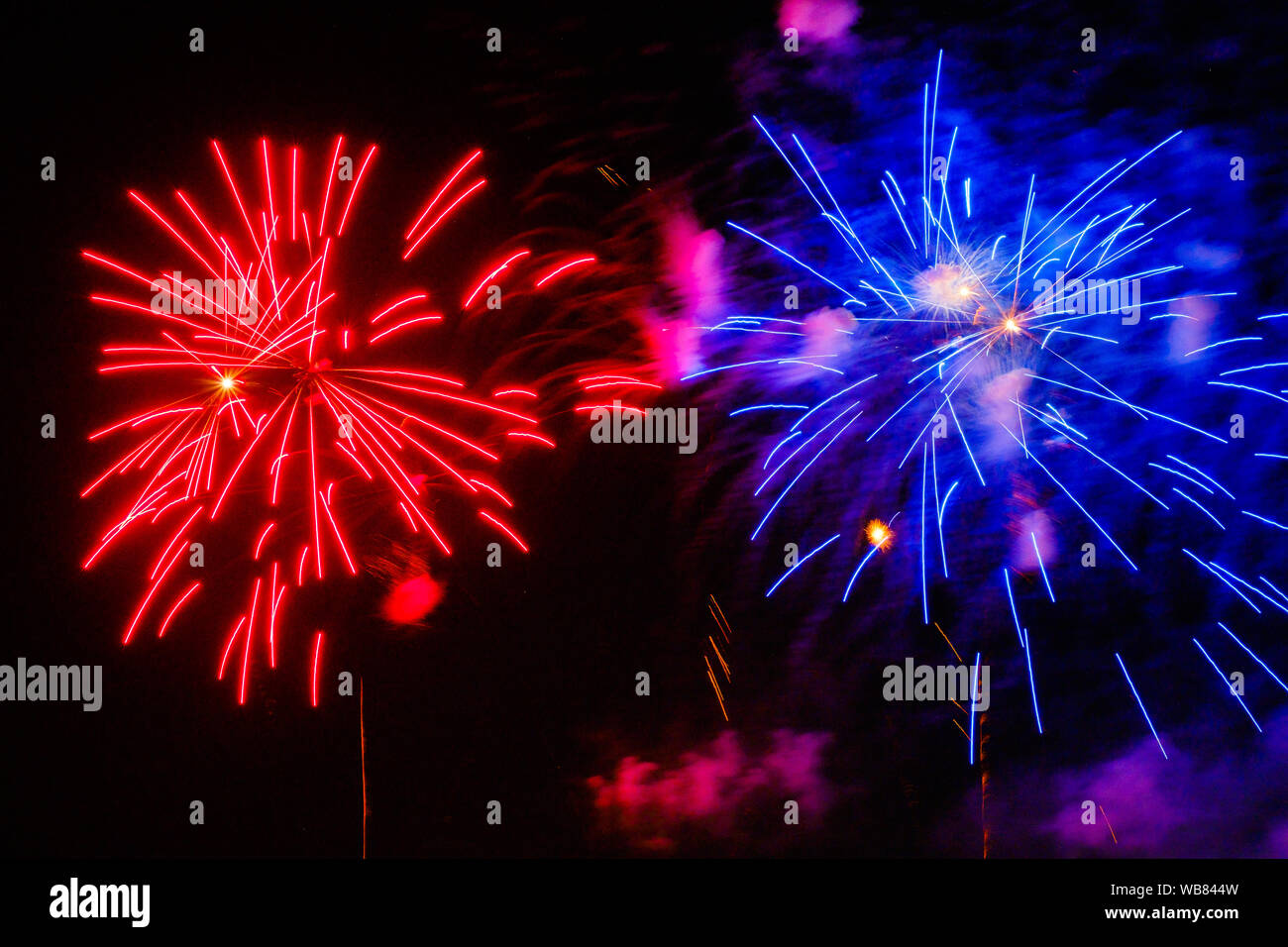 Colorful fireworks in night sky background Stock Photo - Alamy