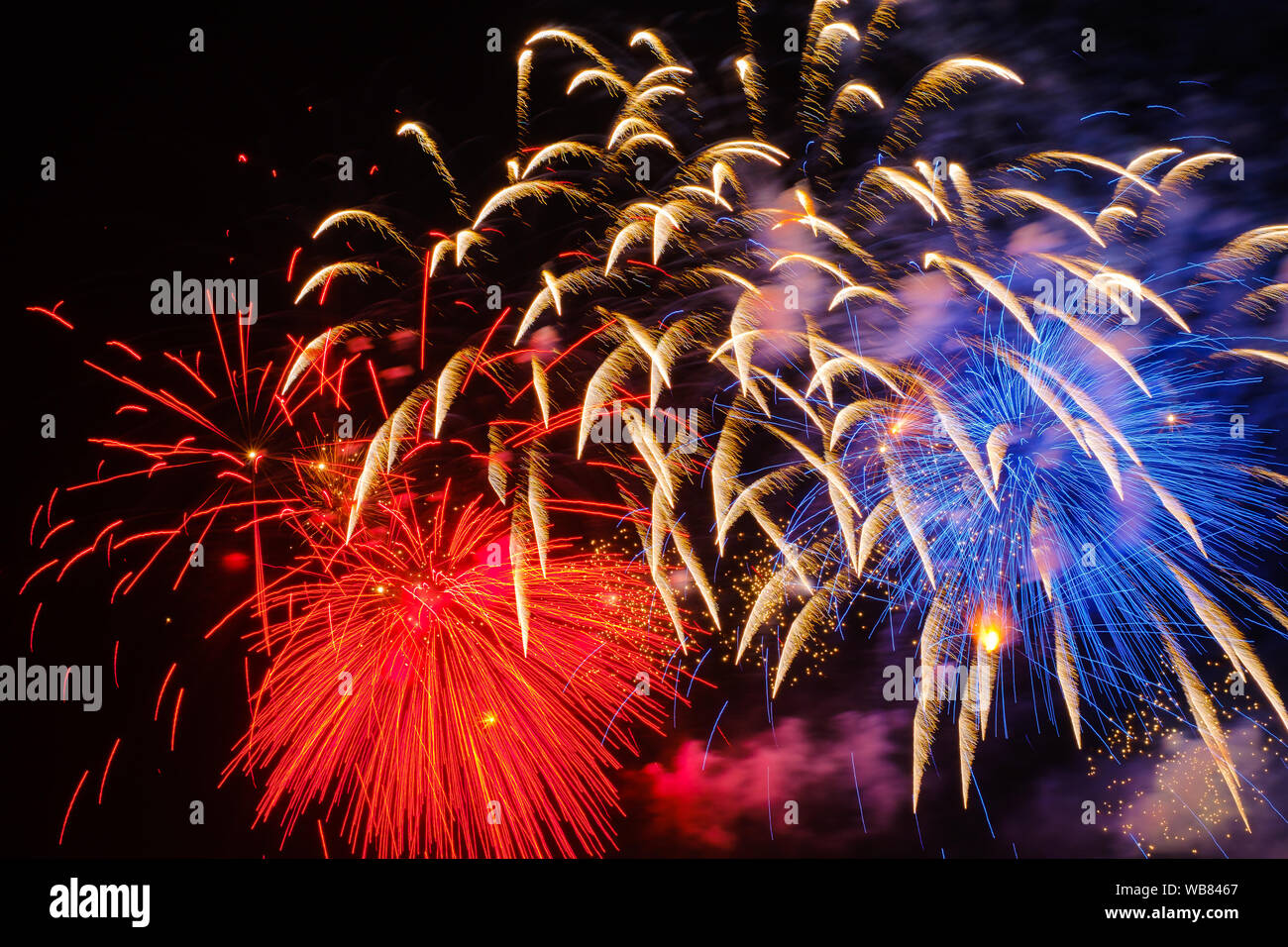 Colorful fireworks in night sky background Stock Photo - Alamy