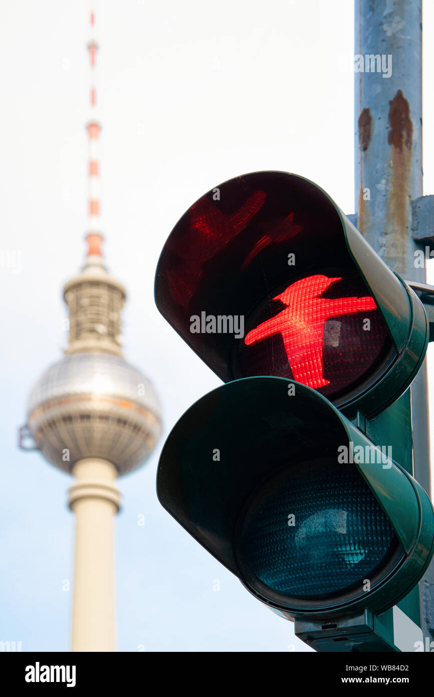 Red traffic light and Television tower on the background in Berlin ...