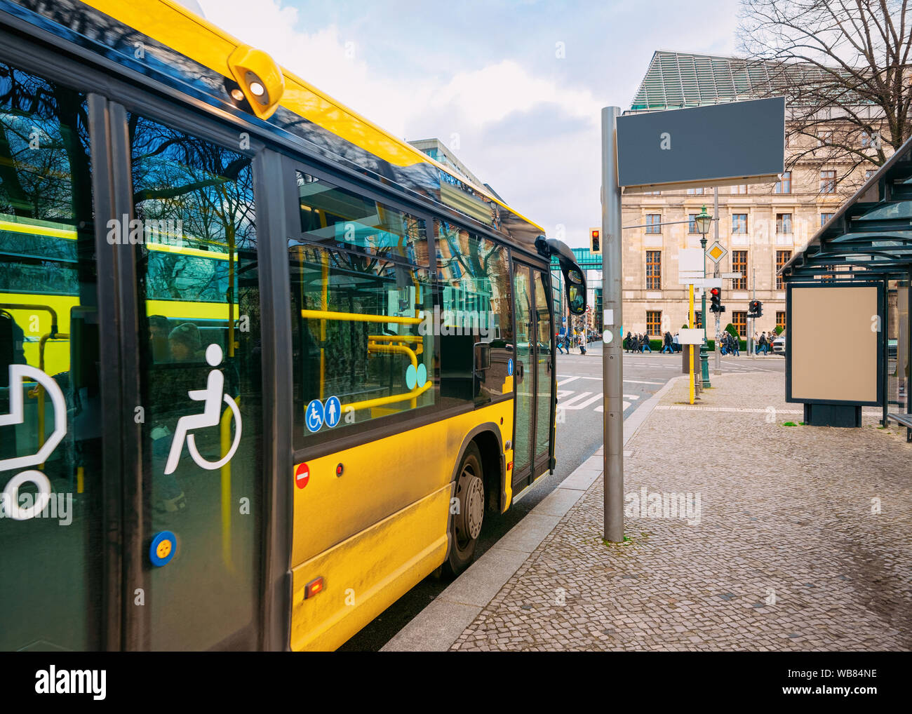 Yellow public bus with entrance door for people with disability at the ...