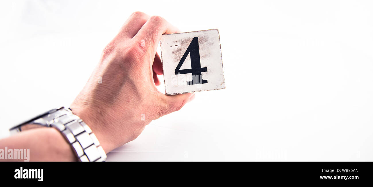 A hand holding digit number 4 (four) on white background Stock Photo ...