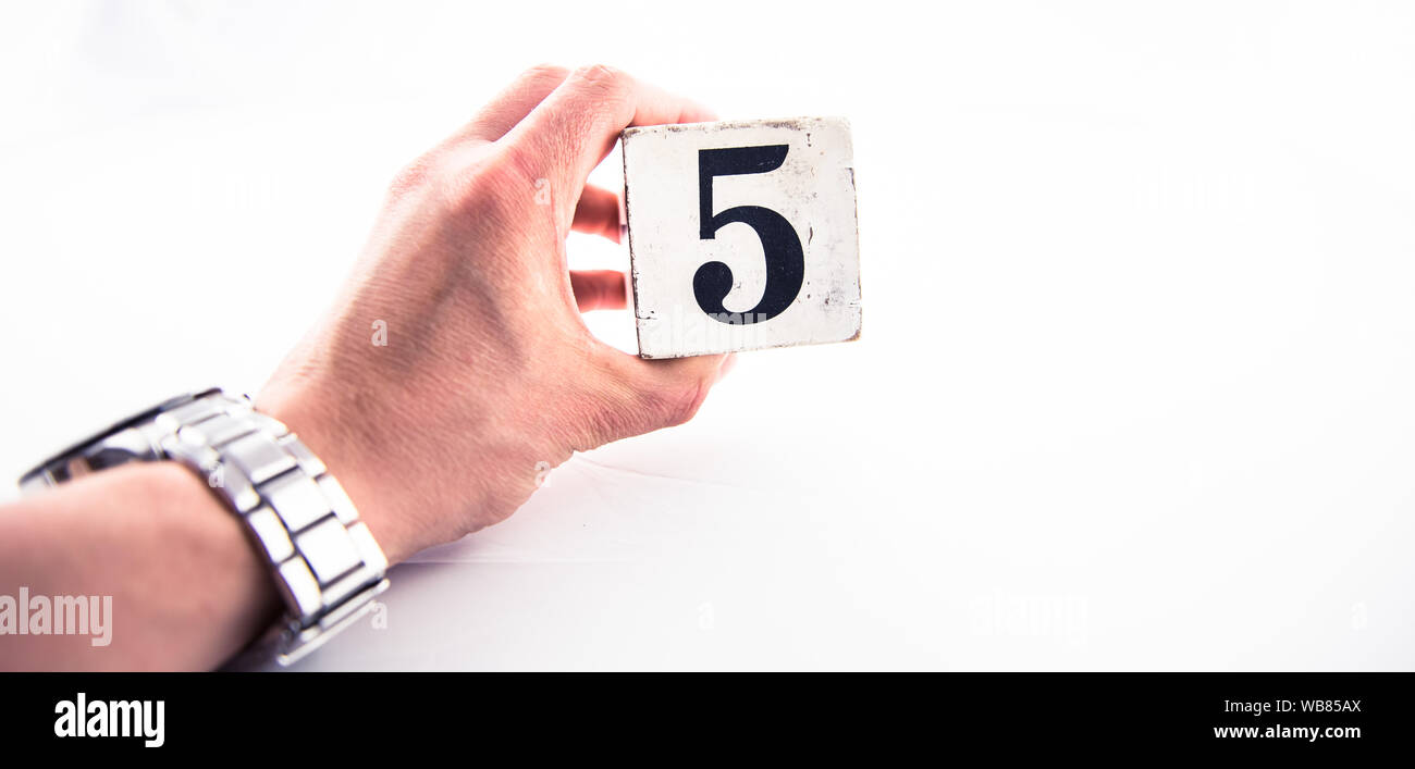 A hand holding digit number 5 (five) on white background Stock Photo ...