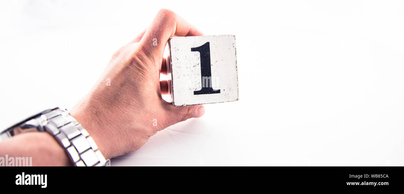 A hand holding digit number 1 (one) on white background Stock Photo - Alamy