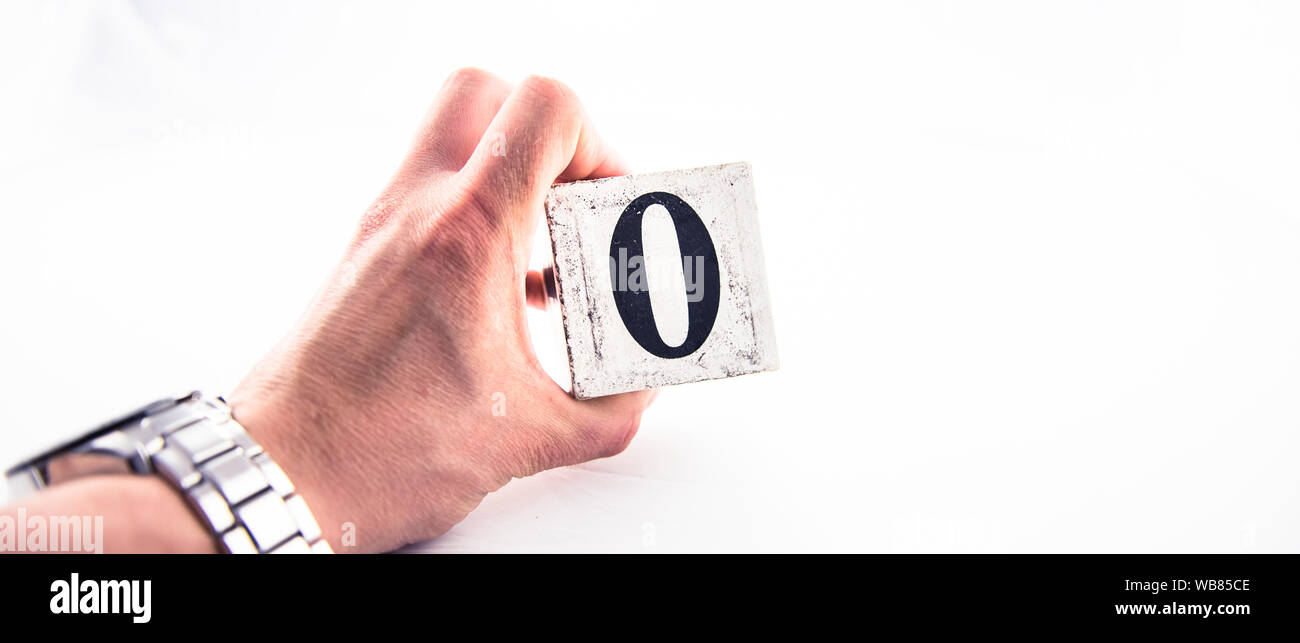 A hand holding digit number 0 (zero) on white background Stock Photo ...