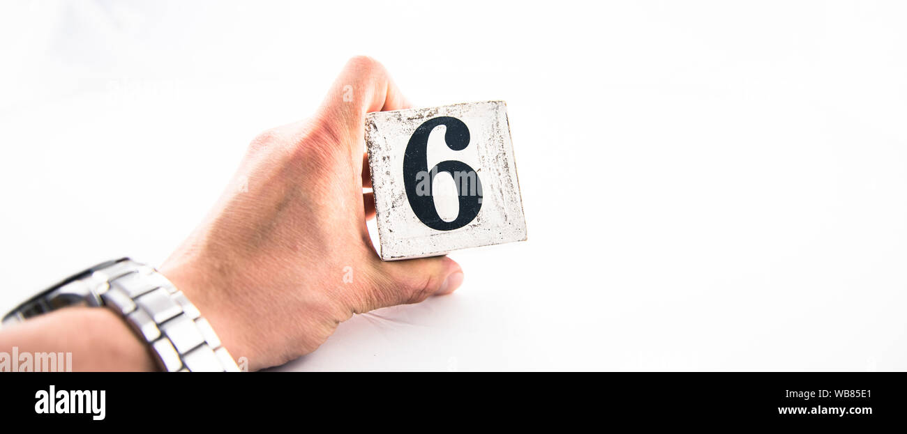 A hand holding digit number 6 (six) on white background Stock Photo - Alamy