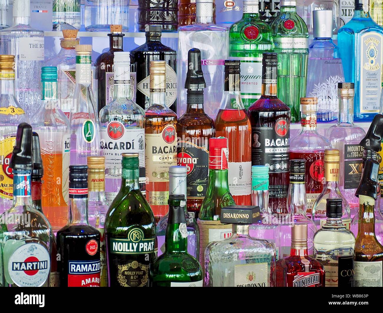 Many bottles of alcohol in a bar to create drinks Stock Photo - Alamy