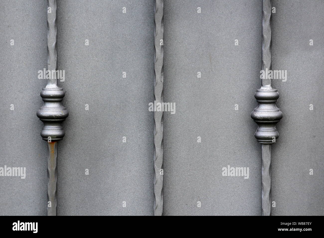 Custom made wrought iron decorative poles mounted on top of dark grey ...