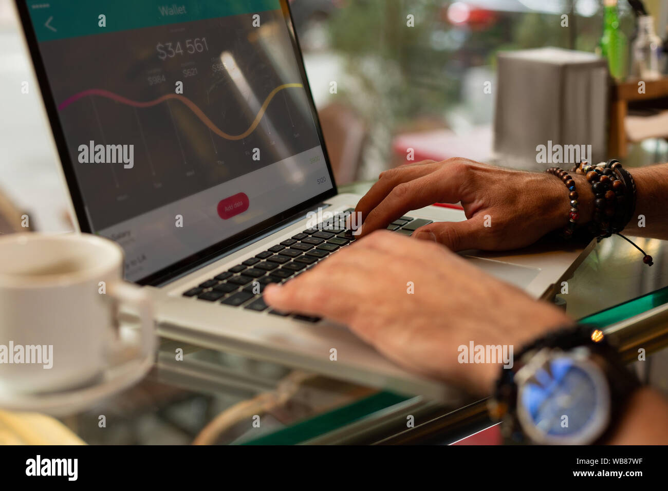 Man calculating the expenses on his laptop Stock Photo - Alamy