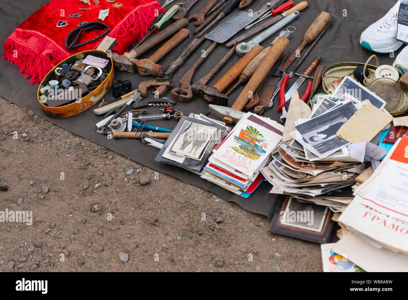 Flea market. Sale of old things. Unnecessary photos. Old hand tools ...