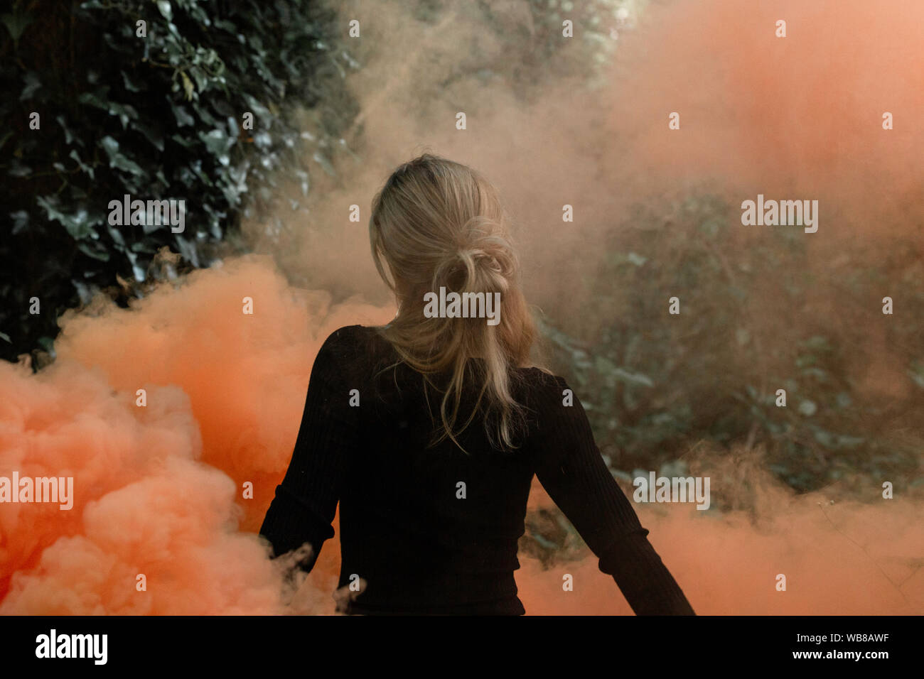 Dancing girl surrounded by smoke Stock Photo - Alamy