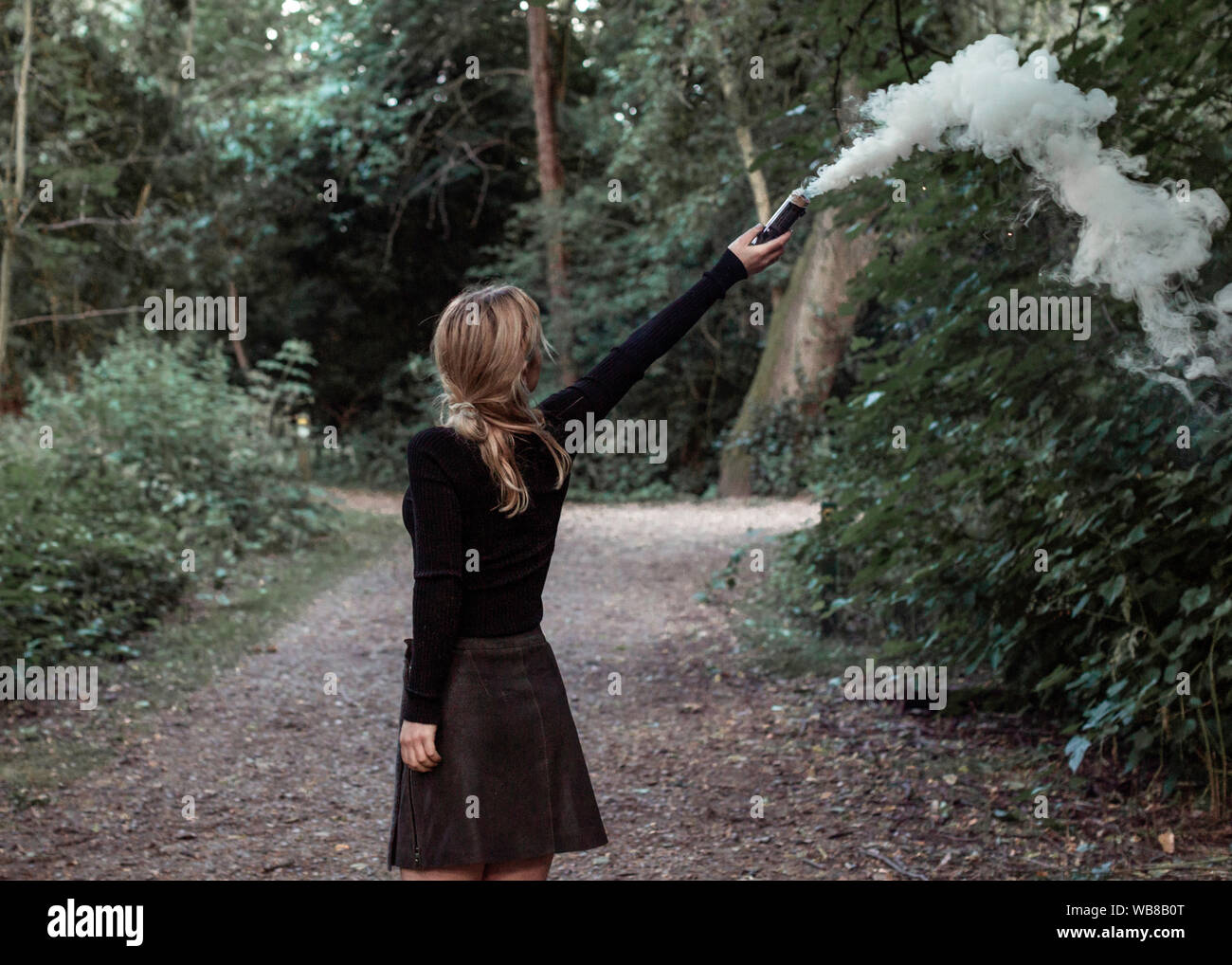 Girl around white smoke in the forest Stock Photo - Alamy