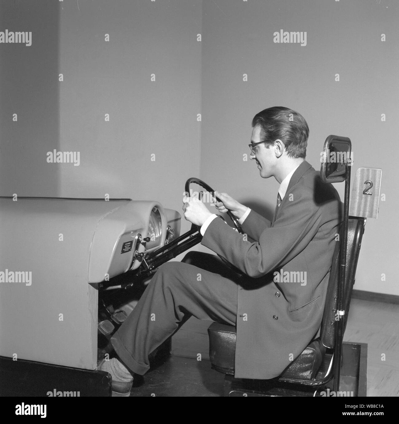 Learning to drive in the 1950s. A young man attends a driving school ...