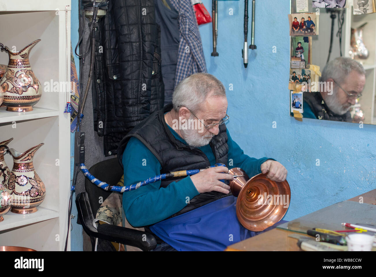 Coppersmith is working in his shop in Suleymaniye, Istanbul. Copper ...